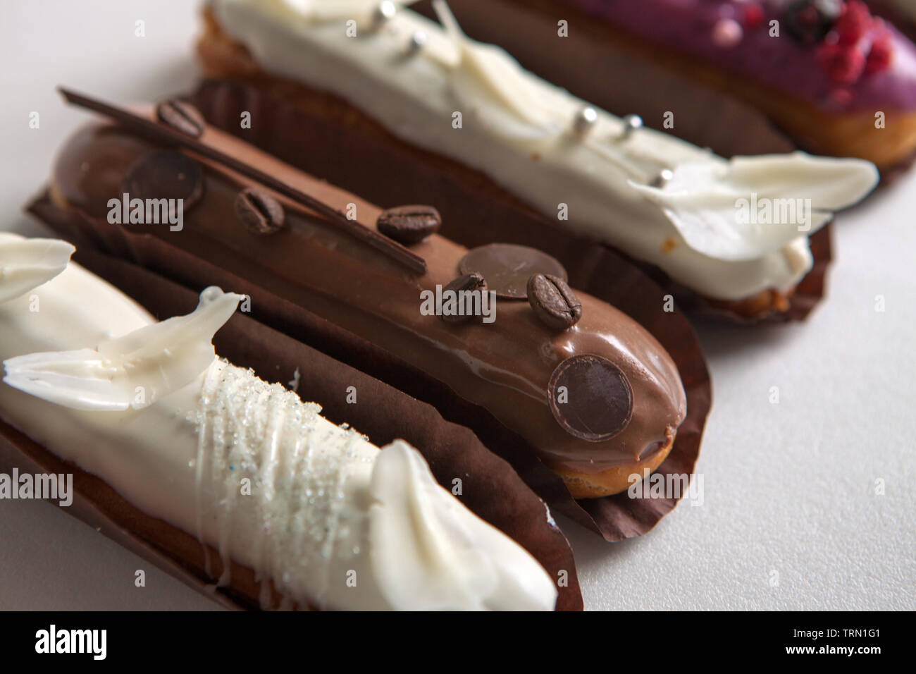Set of several eclairs with various fillings and design isolate on a ...