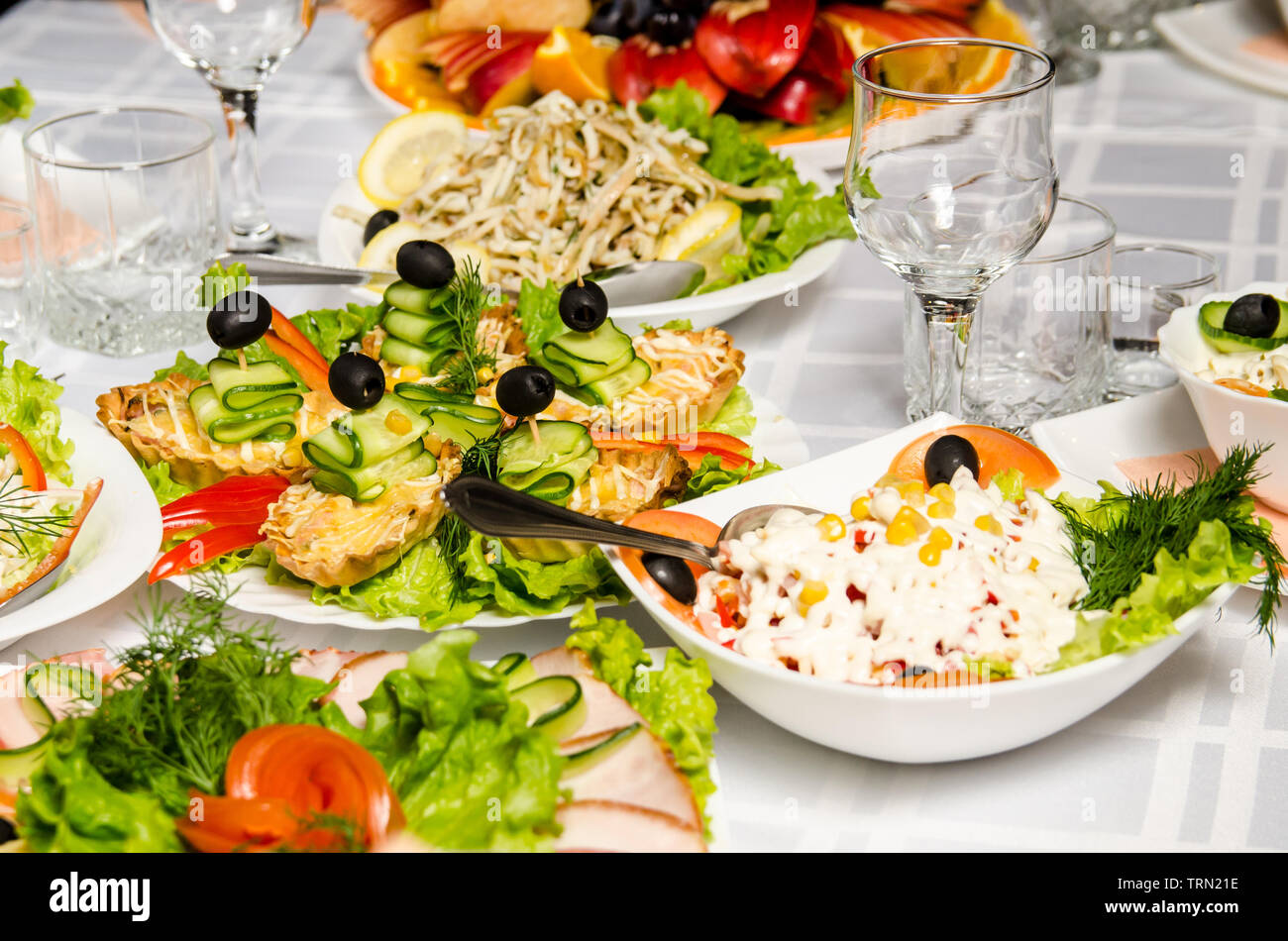 table lined with variety of dishes from which the centerpiece is dish ...