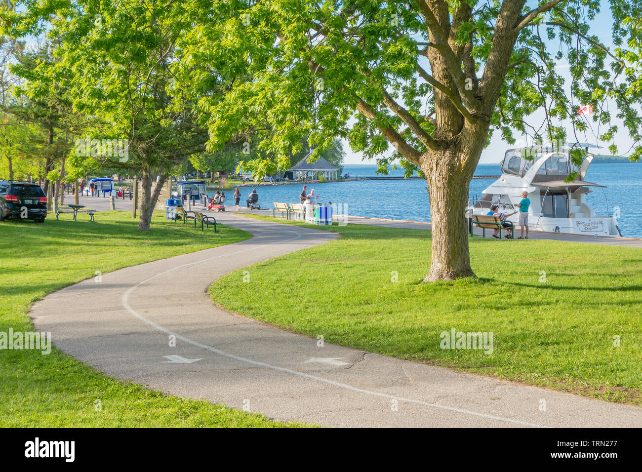 People enjoying a pleasant June evening at Couchiching Beach Park in ...