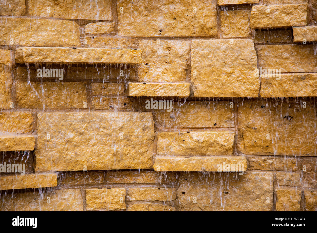 Stone Wall with Falling Water Stock Photo - Alamy