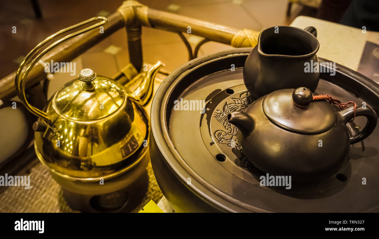 Chinese tea brewing using traditional tea pot, distributing cup, stove ...