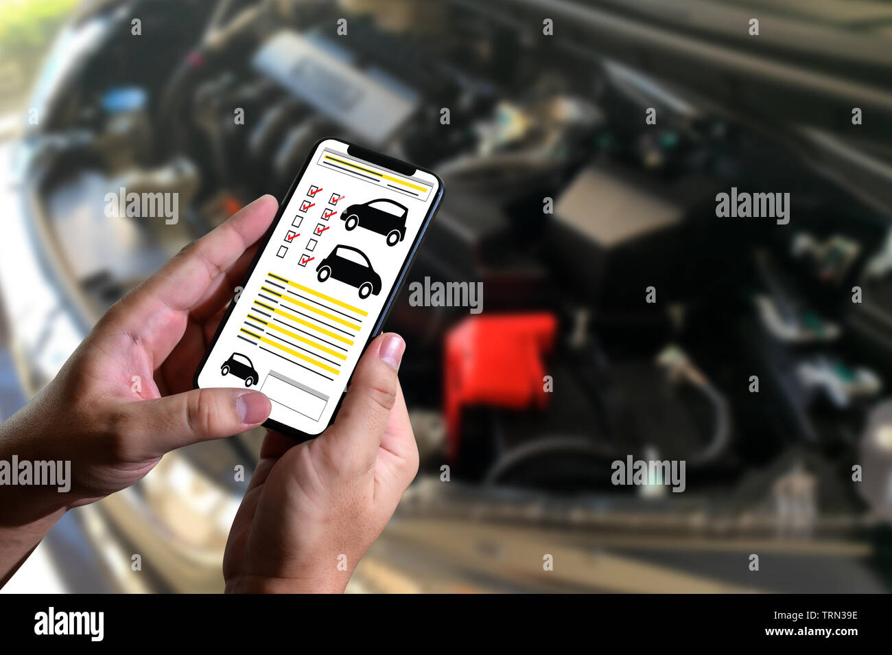 Car service Holding the check list while car mechanic fixing new car ...