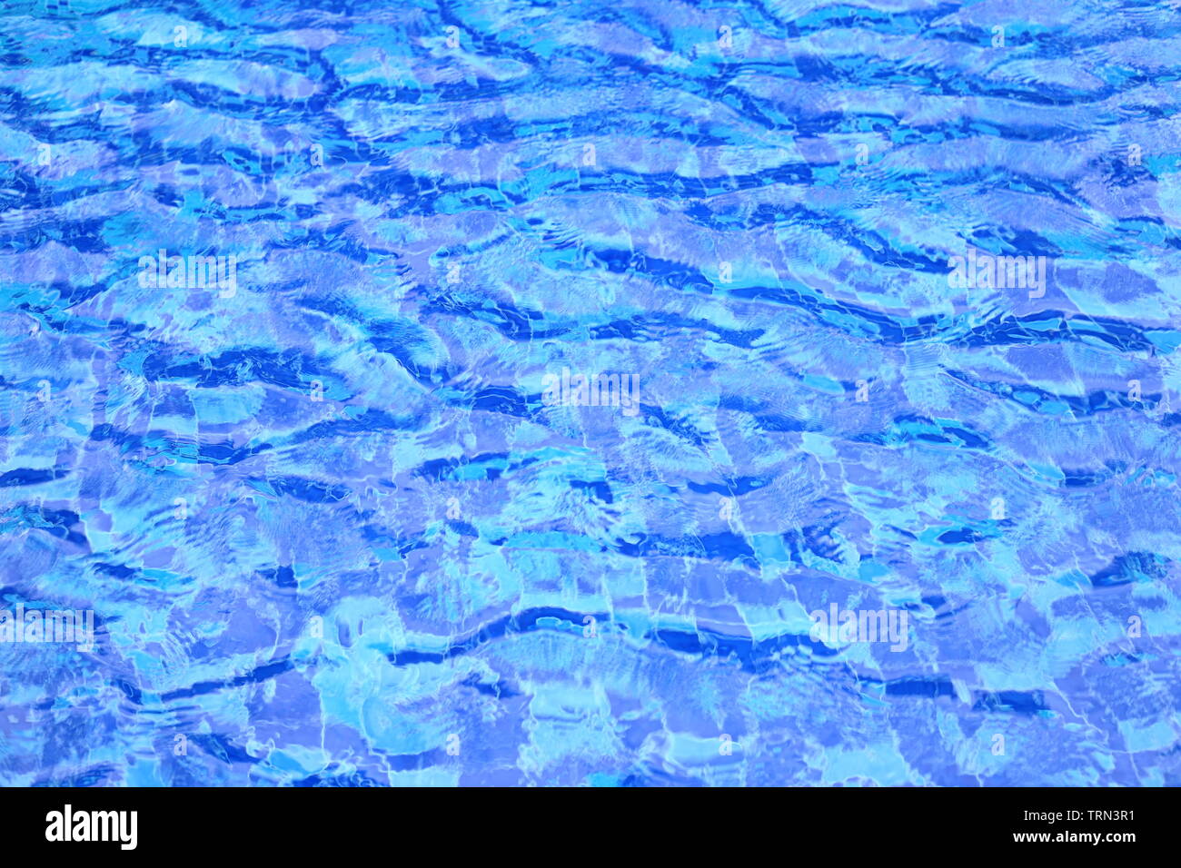 swimming pool ceramic tiles covered in clear water. light blue tiles ...