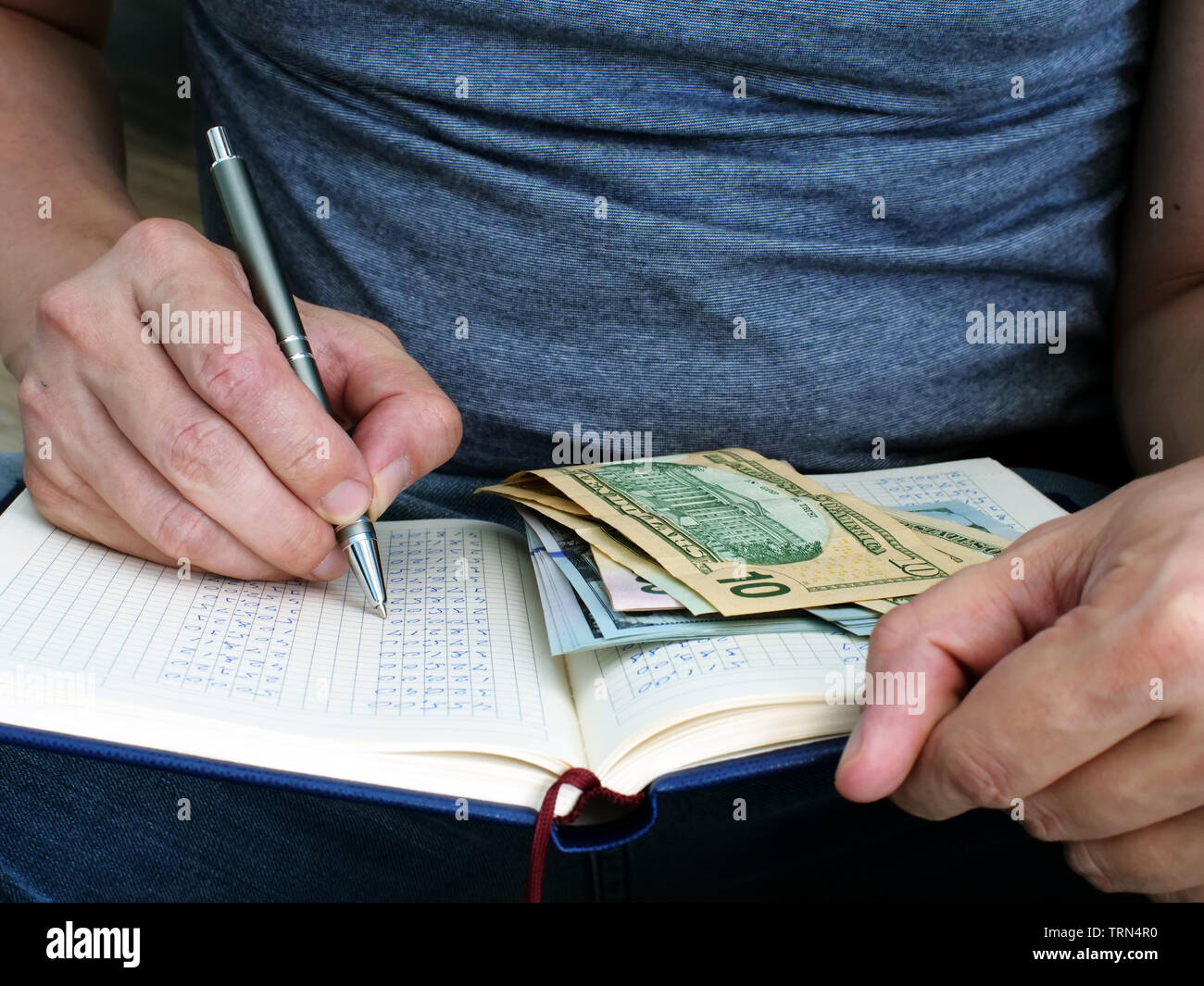 Making calculation of home budget planning Stock Photo - Alamy