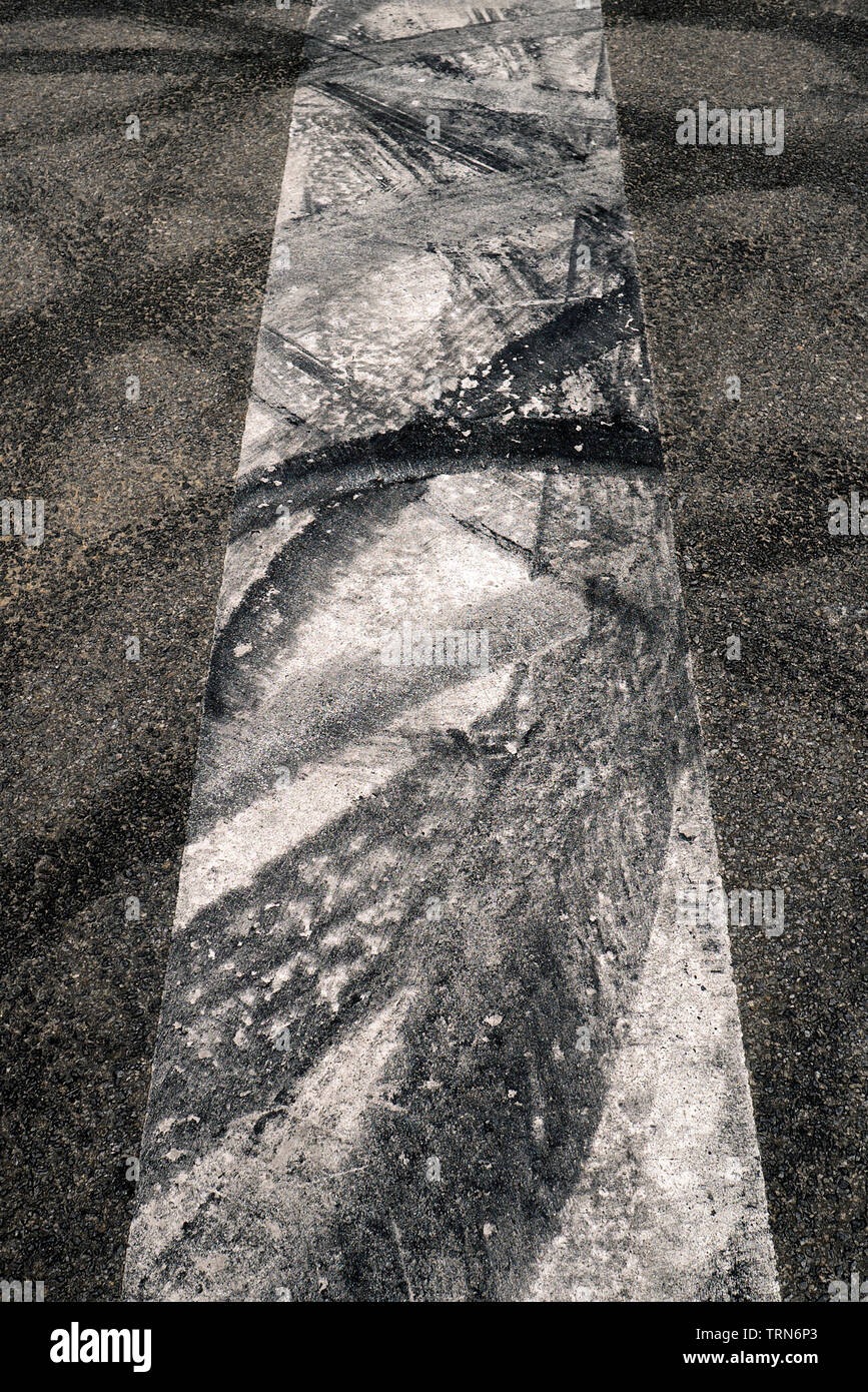 Tyre Marks On White Road Markings Stock Photo - Alamy