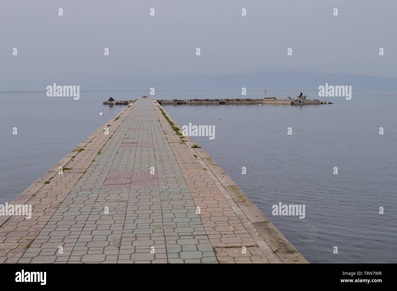 Beautiful lake scene, stone mole on misty background, Lake Ohrid ...