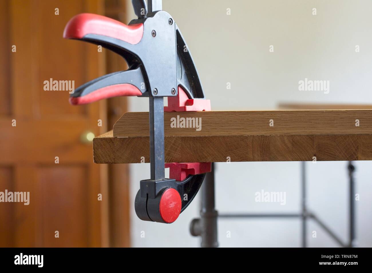 Kitchen upstand held in place by clamps after being glued to a worktop ...
