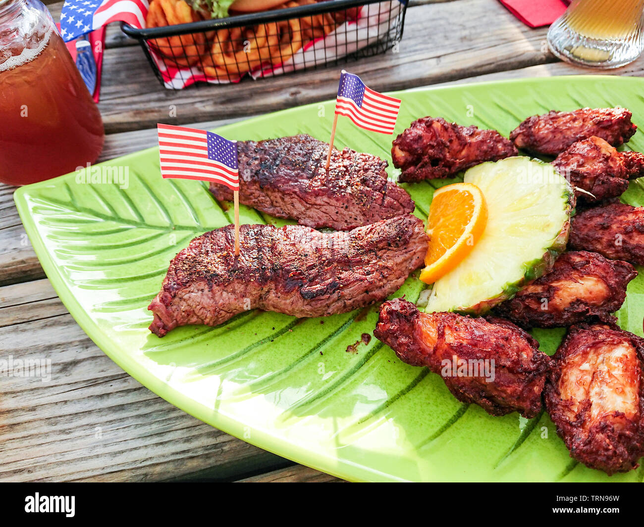 Beef steak with chicken wings and fruits, top view Stock Photo - Alamy