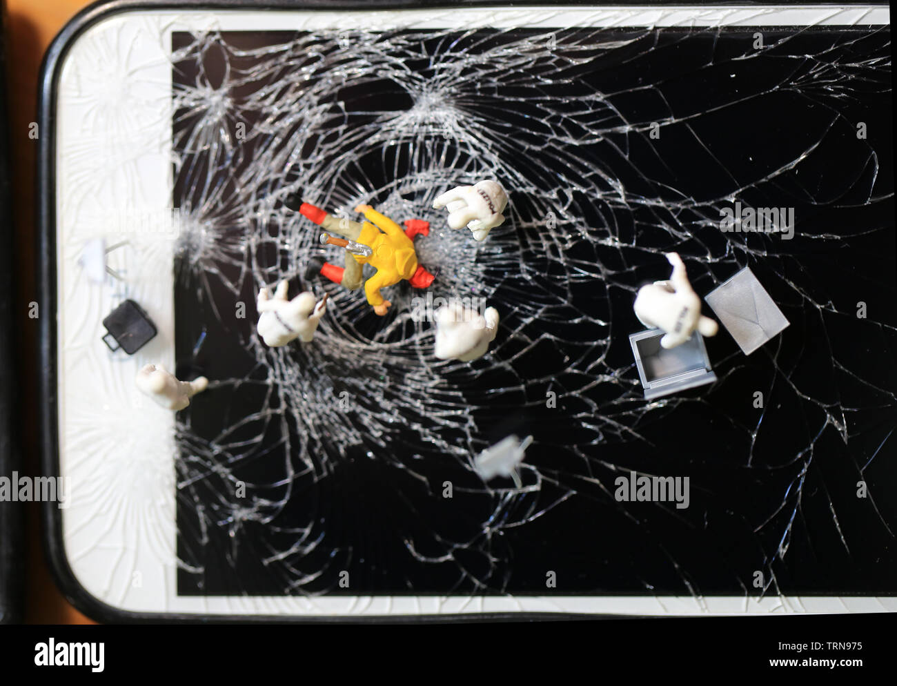 the accident of tiny man falling down on the screen of mobile Stock ...