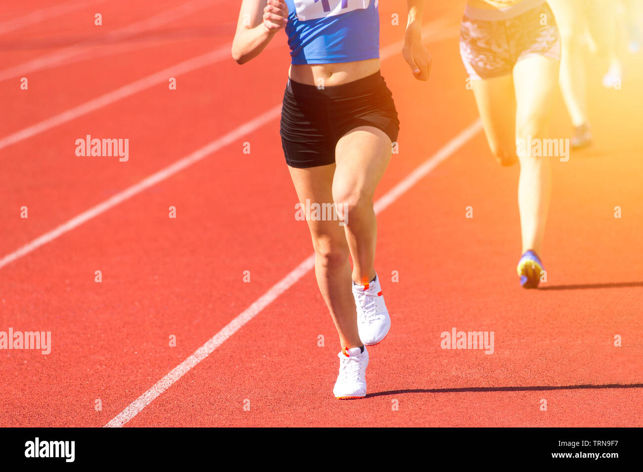 Athletics people running on the track field. Sunny day Stock Photo - Alamy