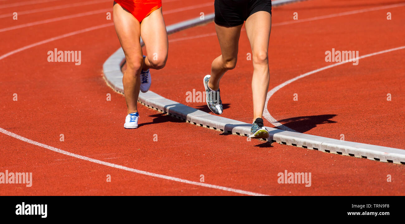 Athletics people running on the track field. Sunny day Stock Photo - Alamy