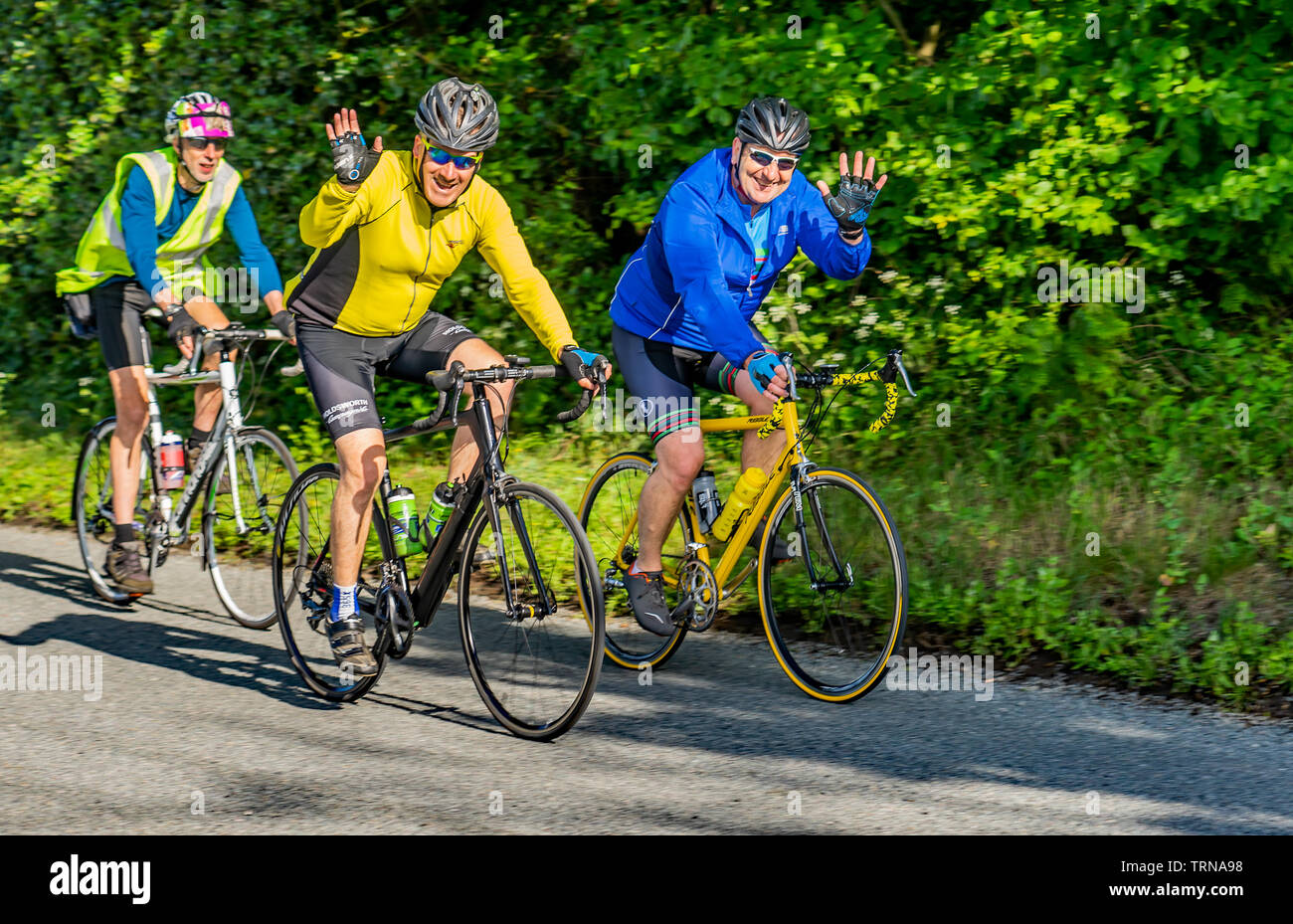 June 2019, Norwich 100 bike ride: Three male cyclists participating in ...