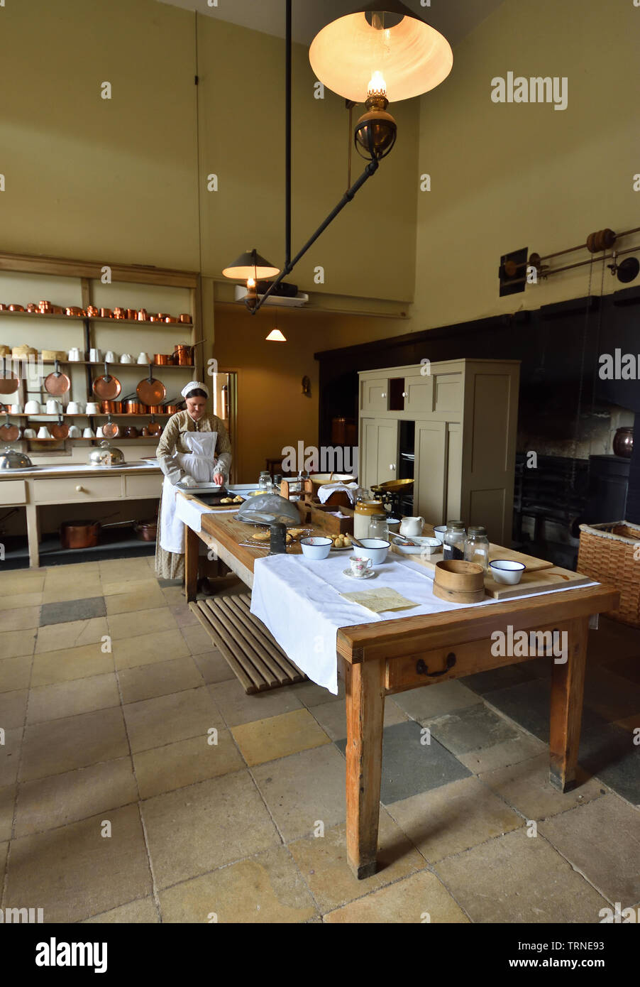 Victorian Kitchen with woman dressed as Victorian Kitchen maid Stock ...