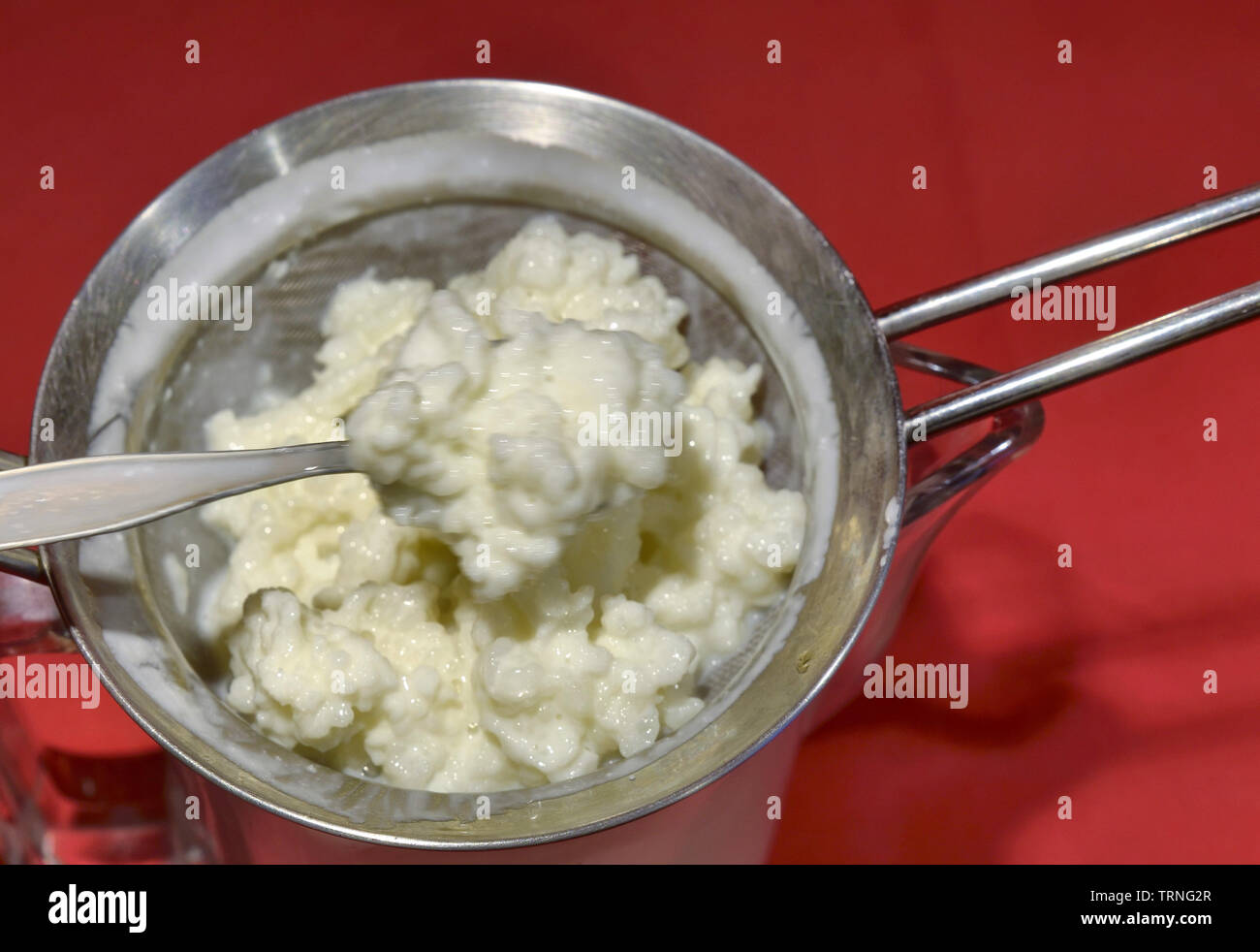 Pouring of the Kefir, the hand of a Caucasian man gently moves the ...