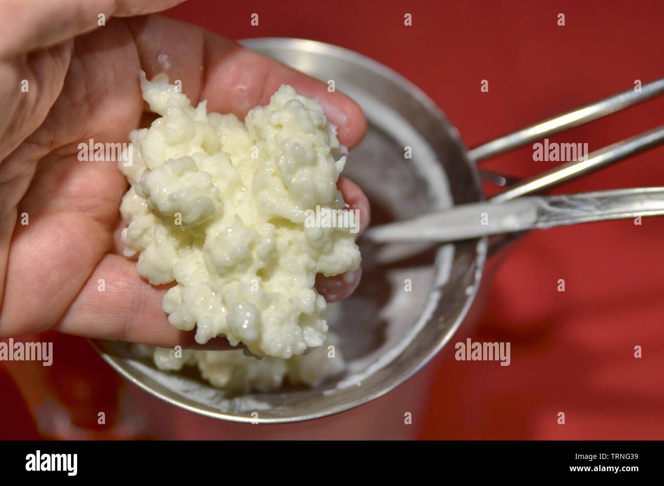 Pouring of the Kefir, the hand of a Caucasian man gently moves the ...