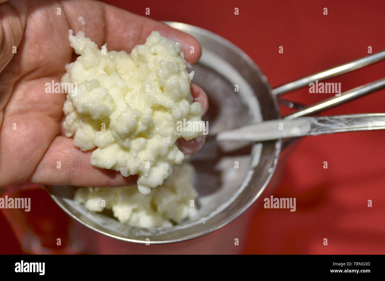 Pouring of the Kefir, the hand of a Caucasian man gently moves the ...