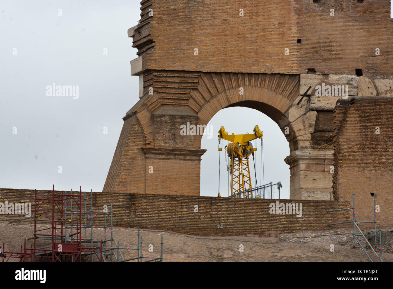 detail of roman coliseum with modern construction machine Stock Photo ...
