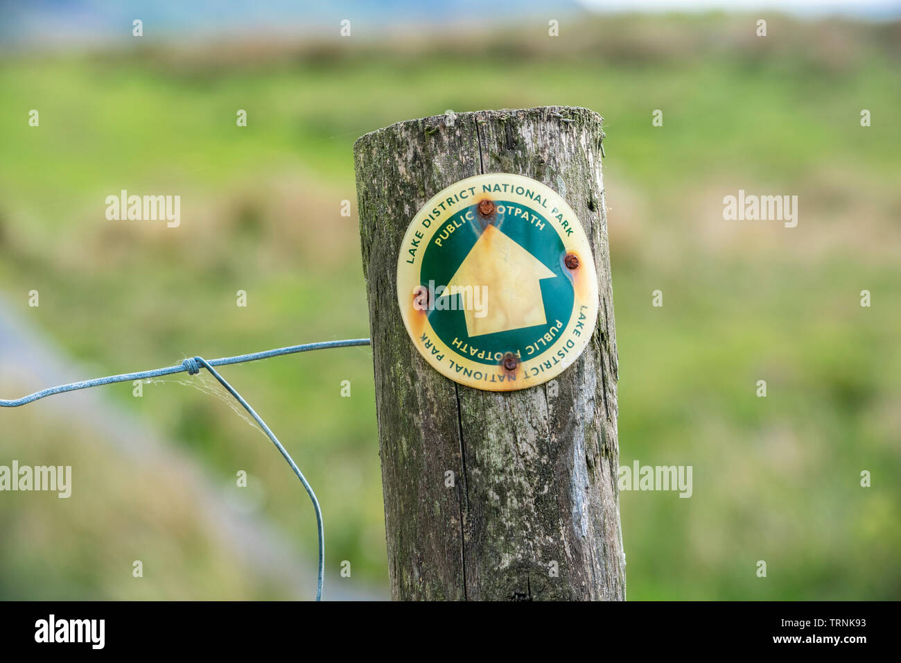 Lake District National Park sign and direction arrow on a fencepost ...