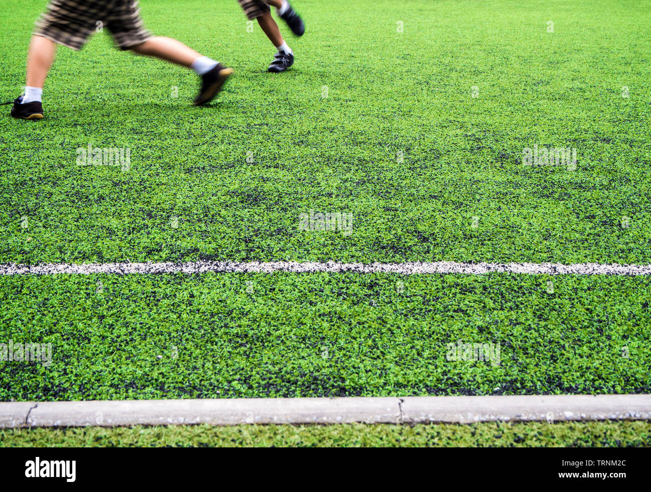 Children play on the artificial turf of the school Stock Photo - Alamy