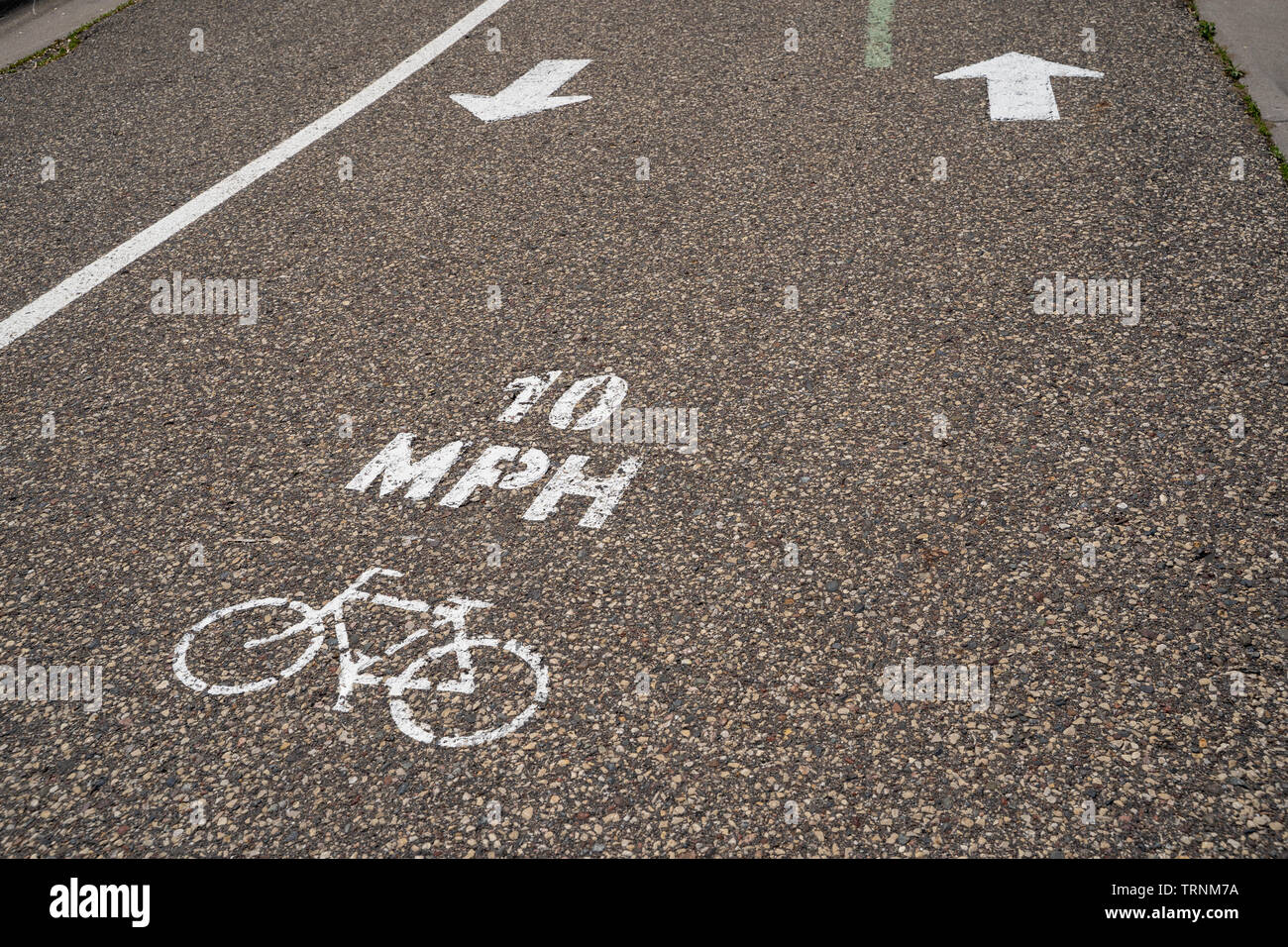 Painted bike lane on pavement indicates a speed limit of 10 miles per ...