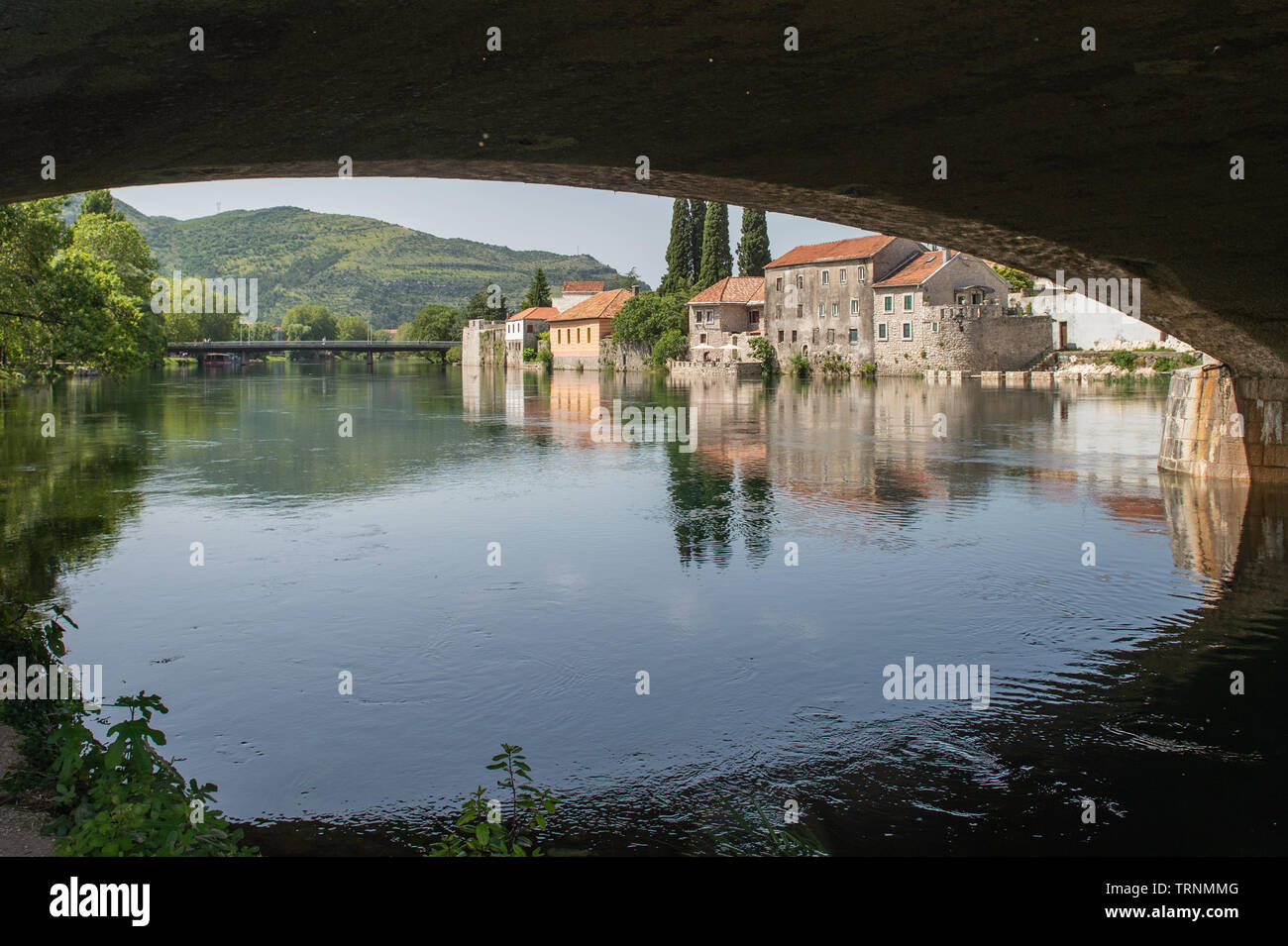 A view from under a road bridge of the Trebišnjica river at city of ...