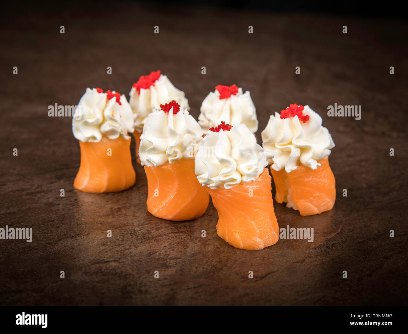 Original rolls with salmon and flying fish roe, stylized cakes Stock ...