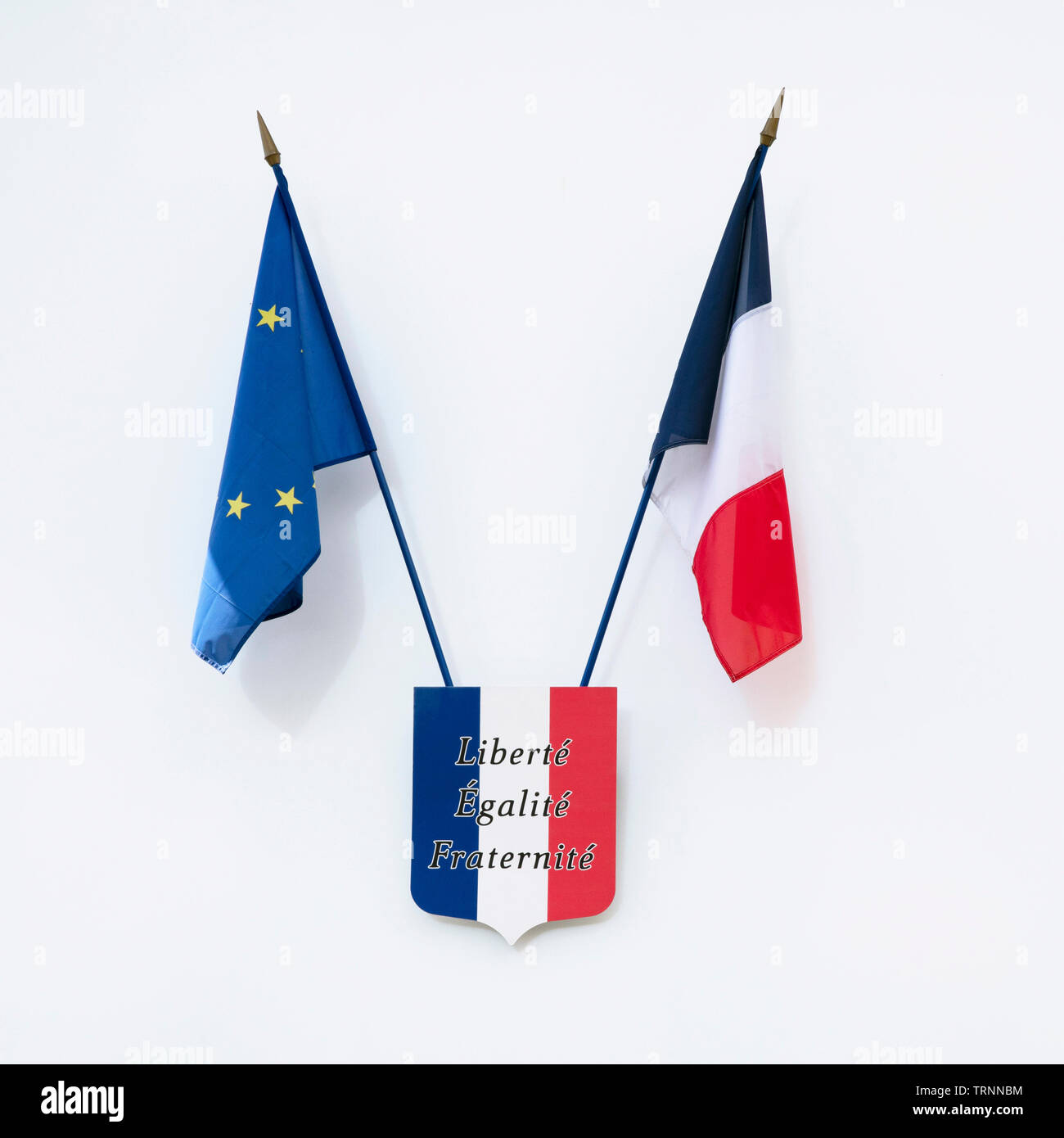 French and European flag above a french coat of arms, on which it is ...