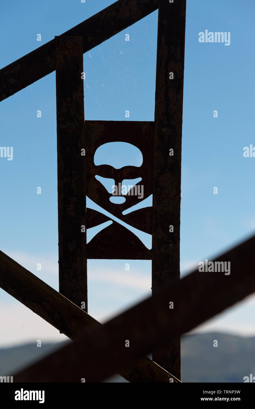 skull and crossbones warning sign on high voltage tower in morocco ...