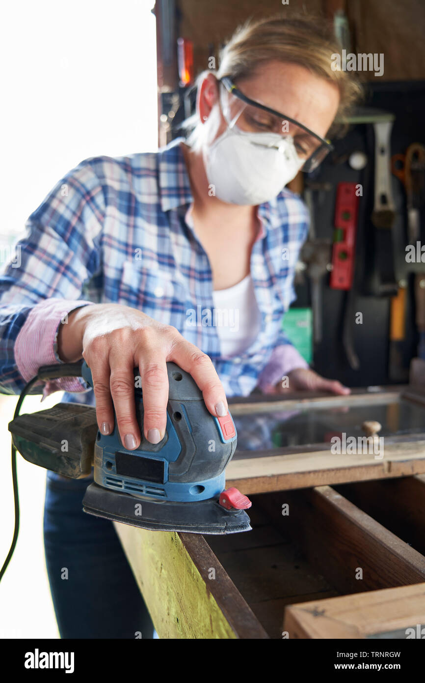 Female electric sander hi-res stock photography and images - Alamy