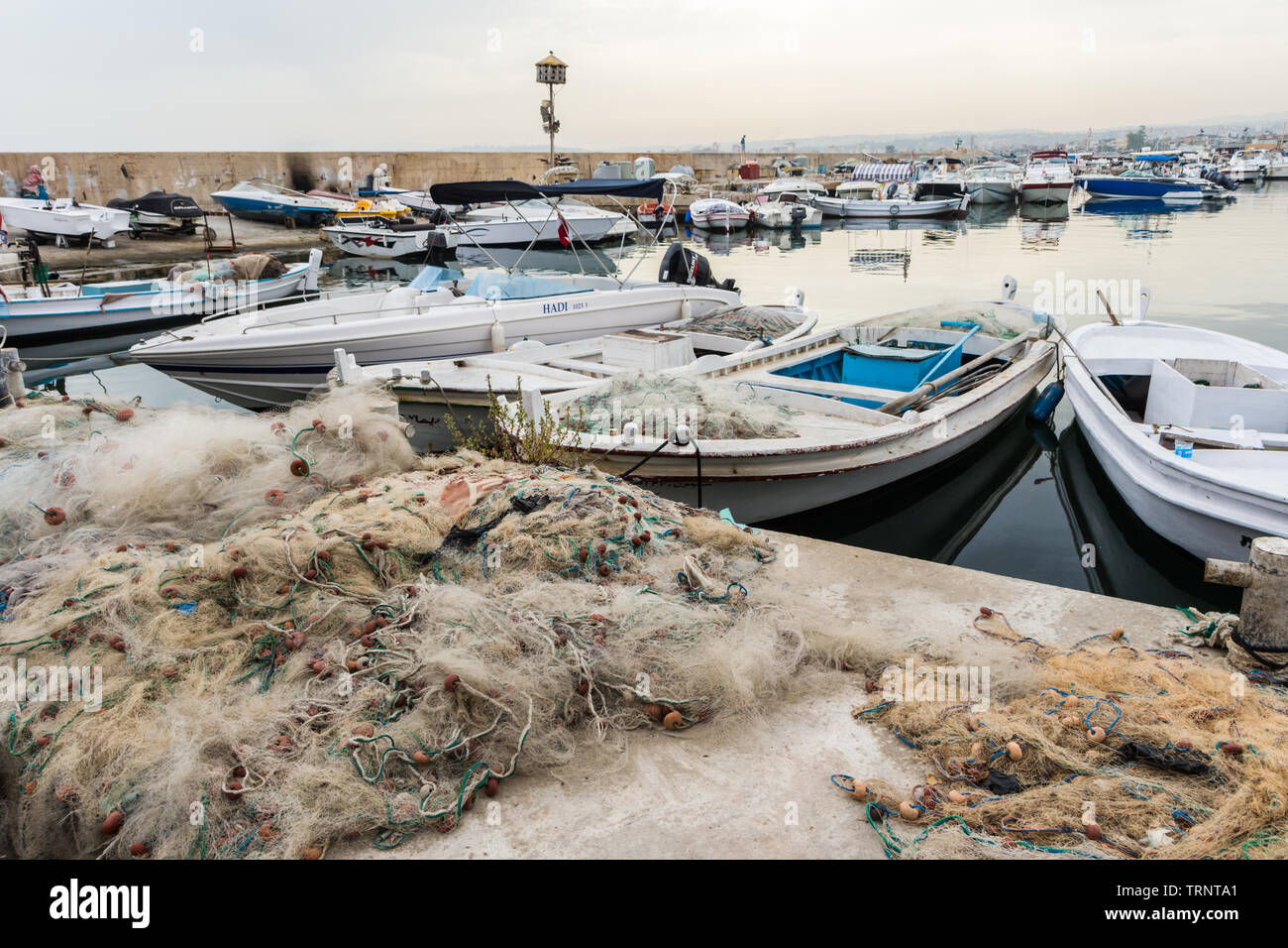 Boats and fishing nets in Tyre harbour in early morning, Tyre, Lebanon ...