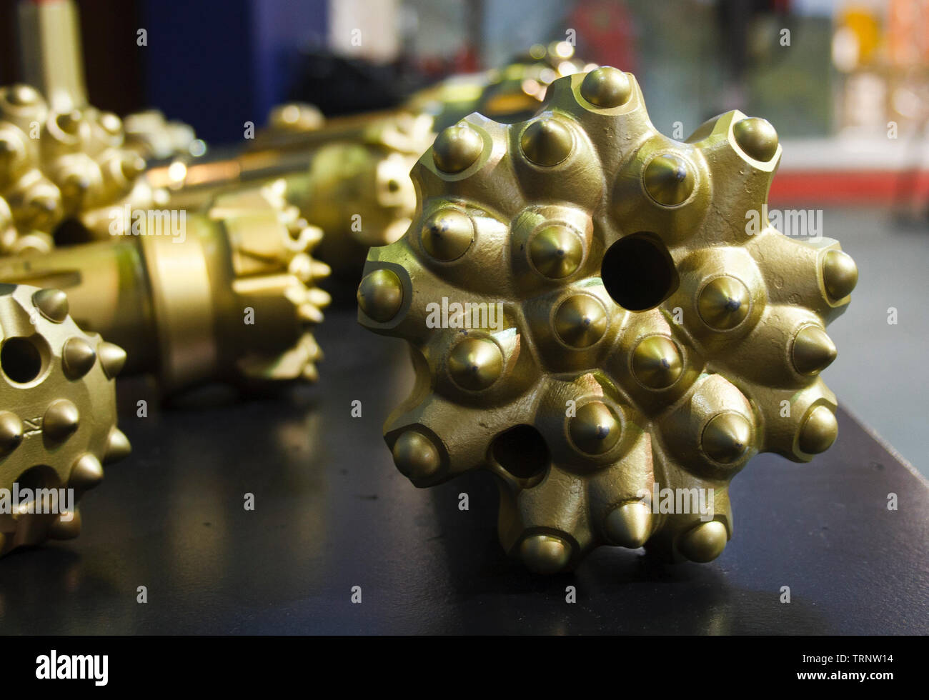 New golden oil rig drill bit detail Stock Photo - Alamy