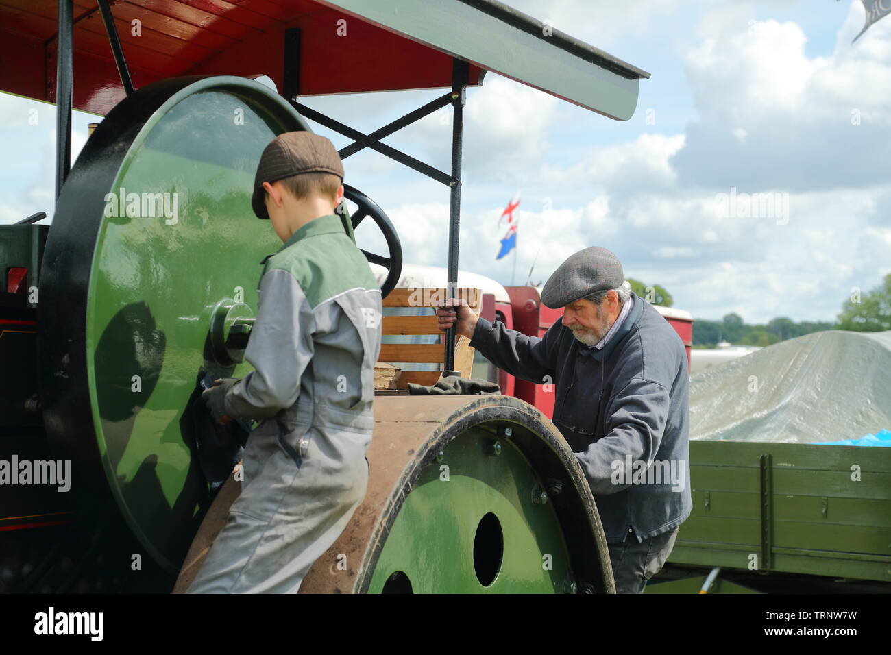 A young and an older man working on a traction engine at the Woodcote ...