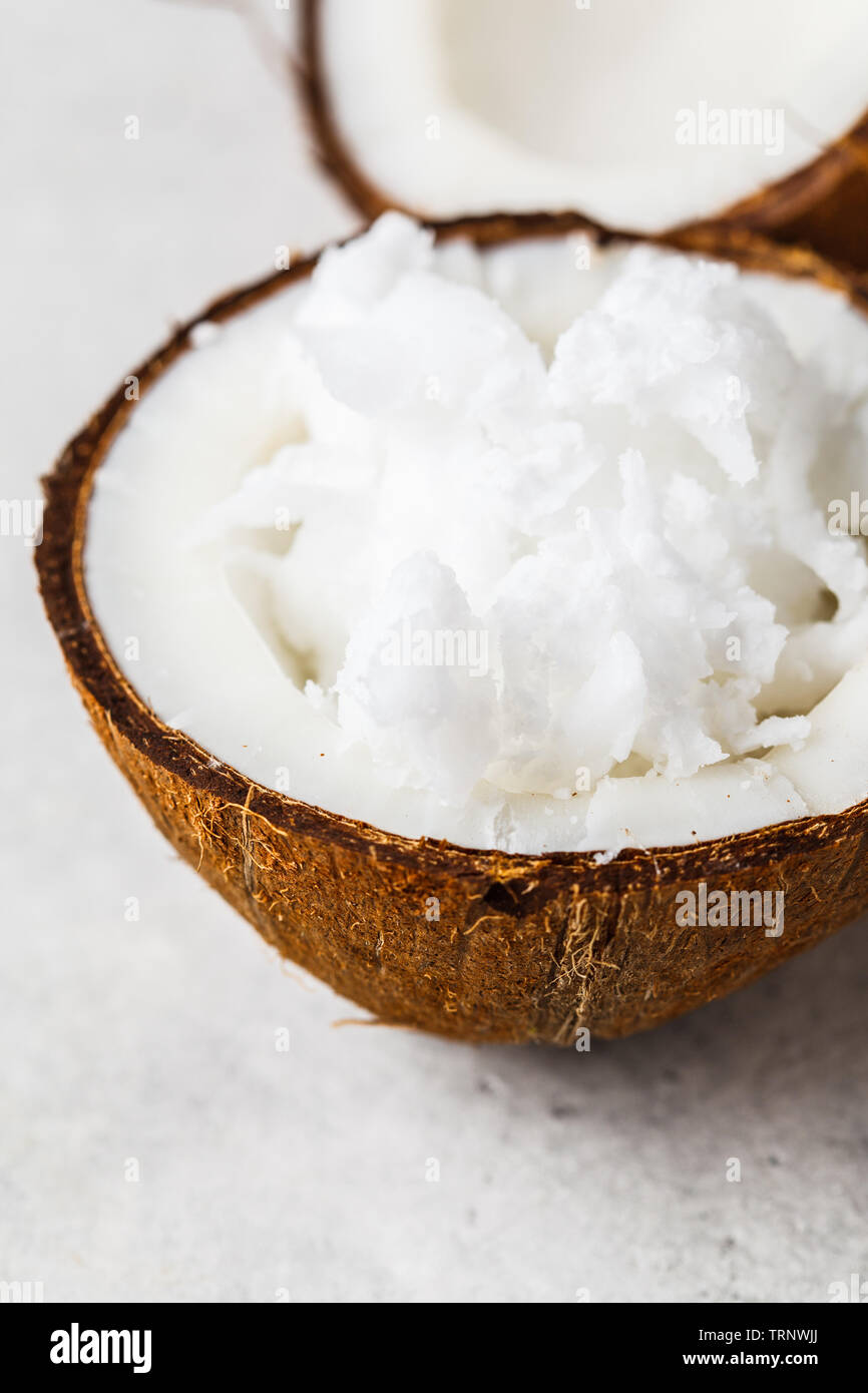 Coconut oil in a coconut shell on gray background Stock Photo - Alamy