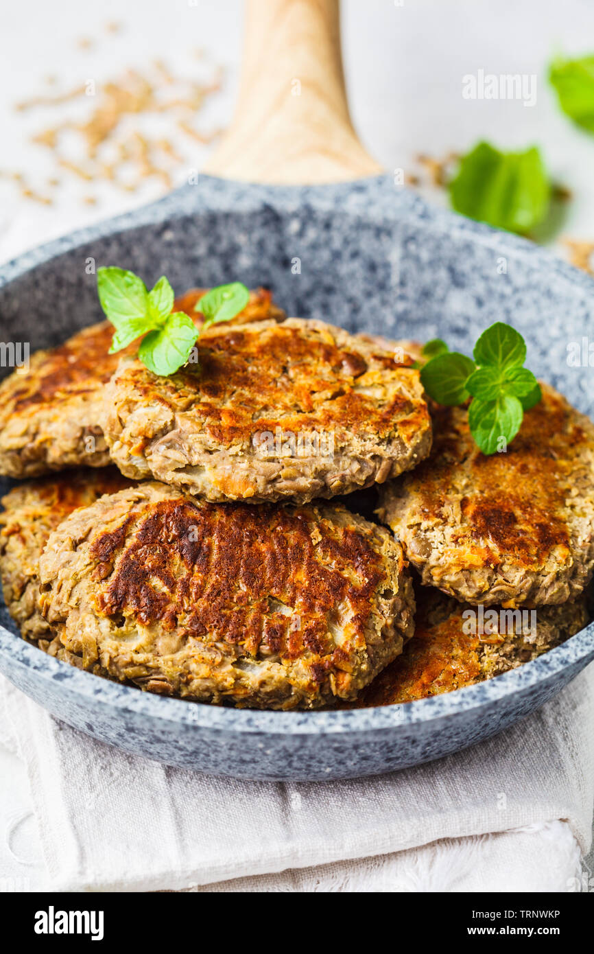 Lentil cutlets in a gray frying pan. Healthy vegan food concept Stock ...