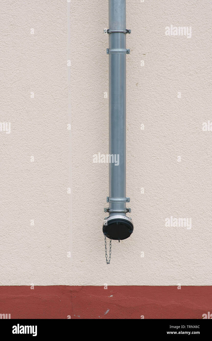 A new Drainpipe on a new outer plaster wall Stock Photo - Alamy