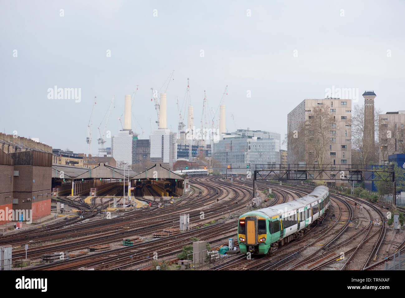 Passenger Trains past Battersea Power Station in London, England Stock ...