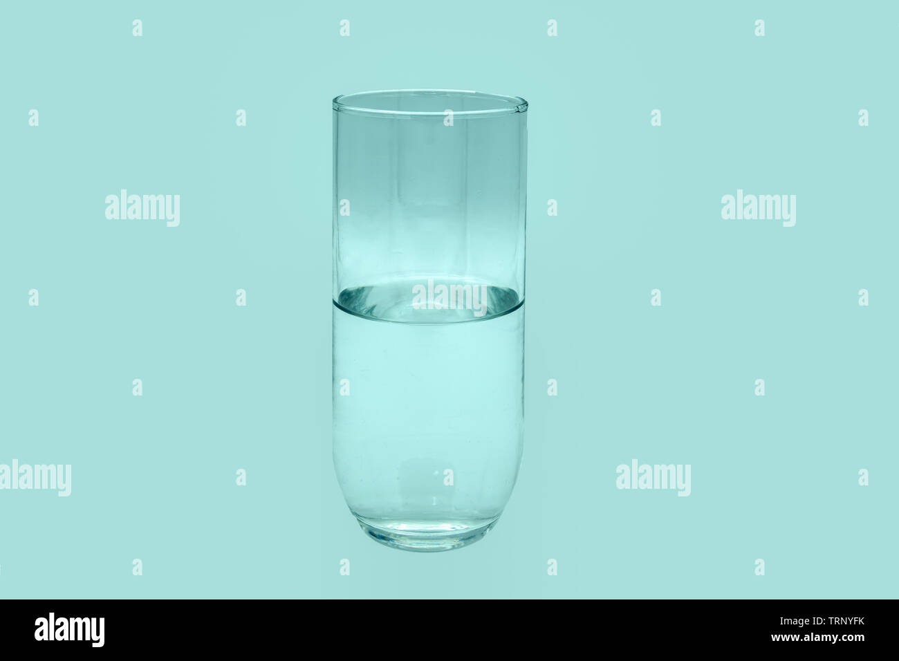 Half a glass of pure water on an isolated background Stock Photo - Alamy
