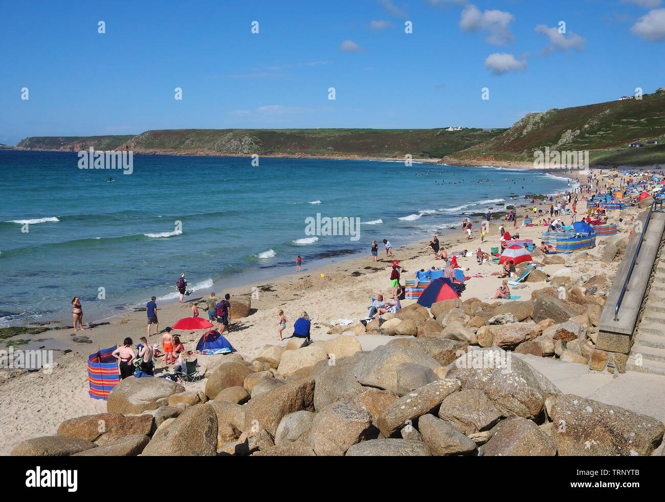People enjoying a sunny summers day on the beach in Sennen Cove ...
