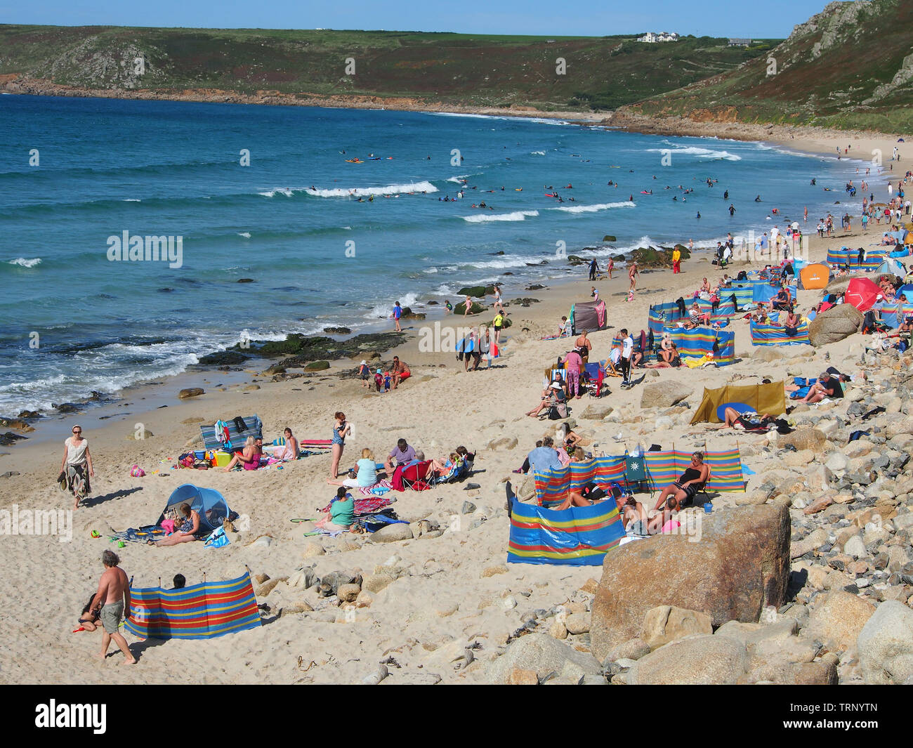 People enjoying a sunny summers day on the beach in Sennen Cove ...