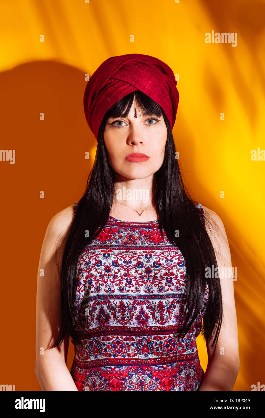 Beautiful indian woman on yellow studio background with shadow and sun ...