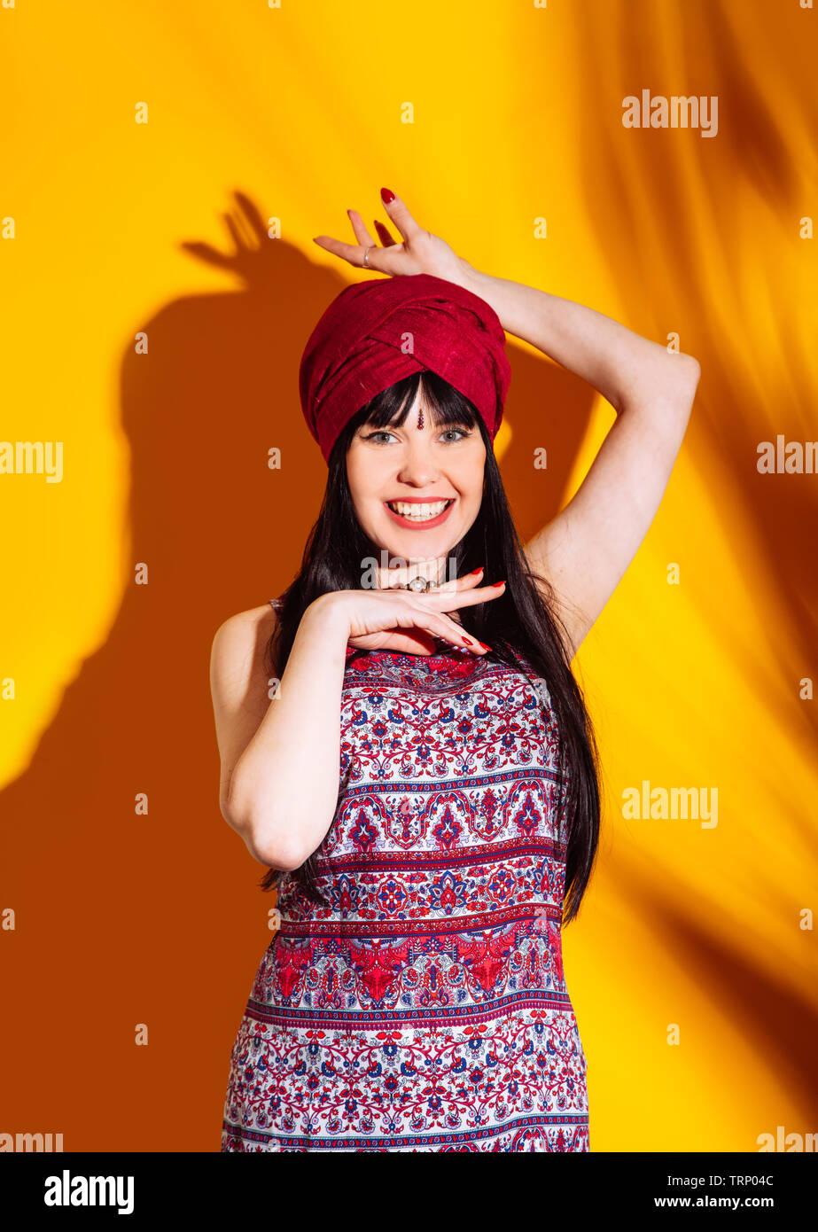 Beautiful indian woman on yellow studio background with shadow and sun ...