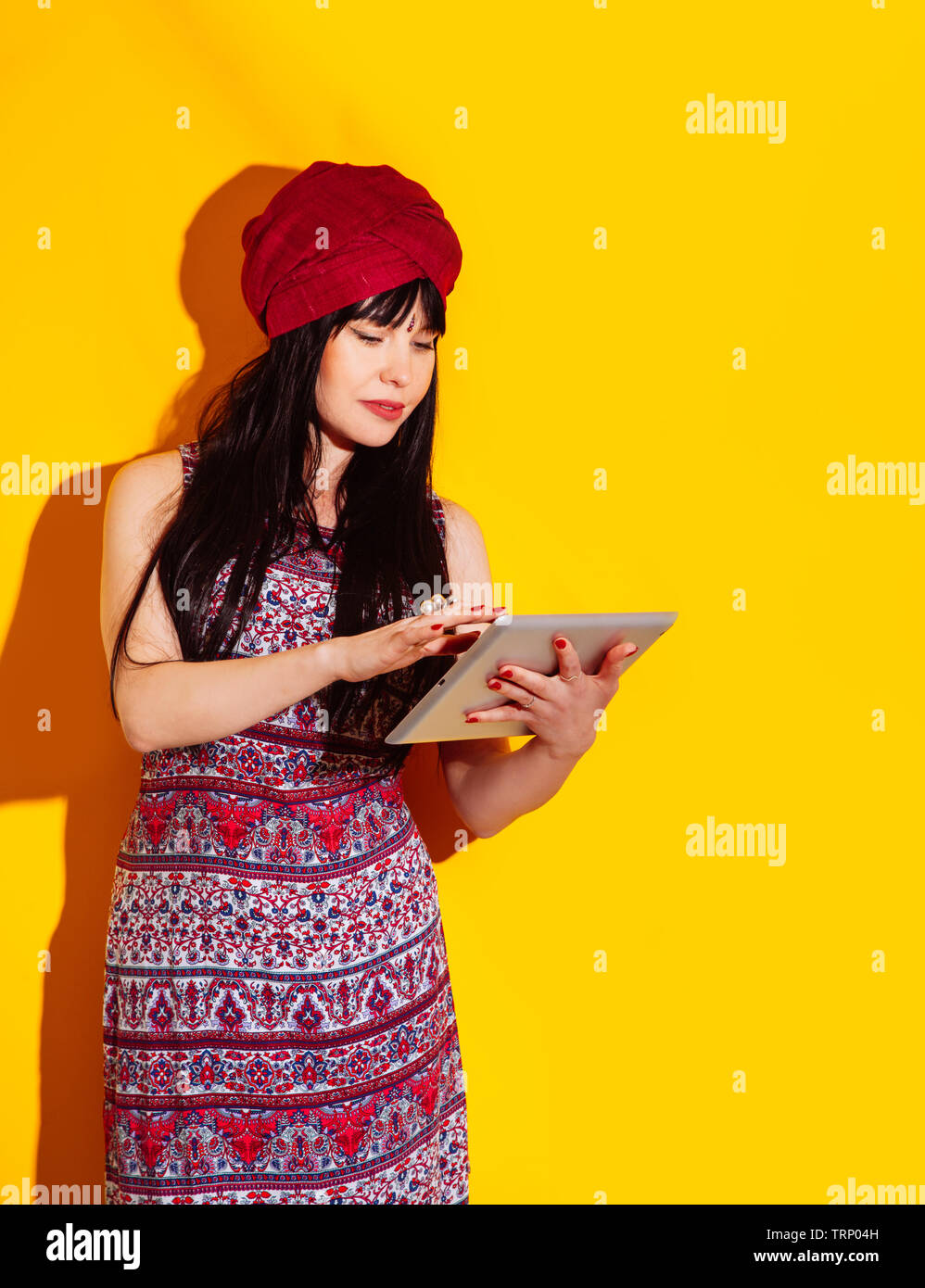 Beautiful indian woman on yellow studio background with shadow and sun ...