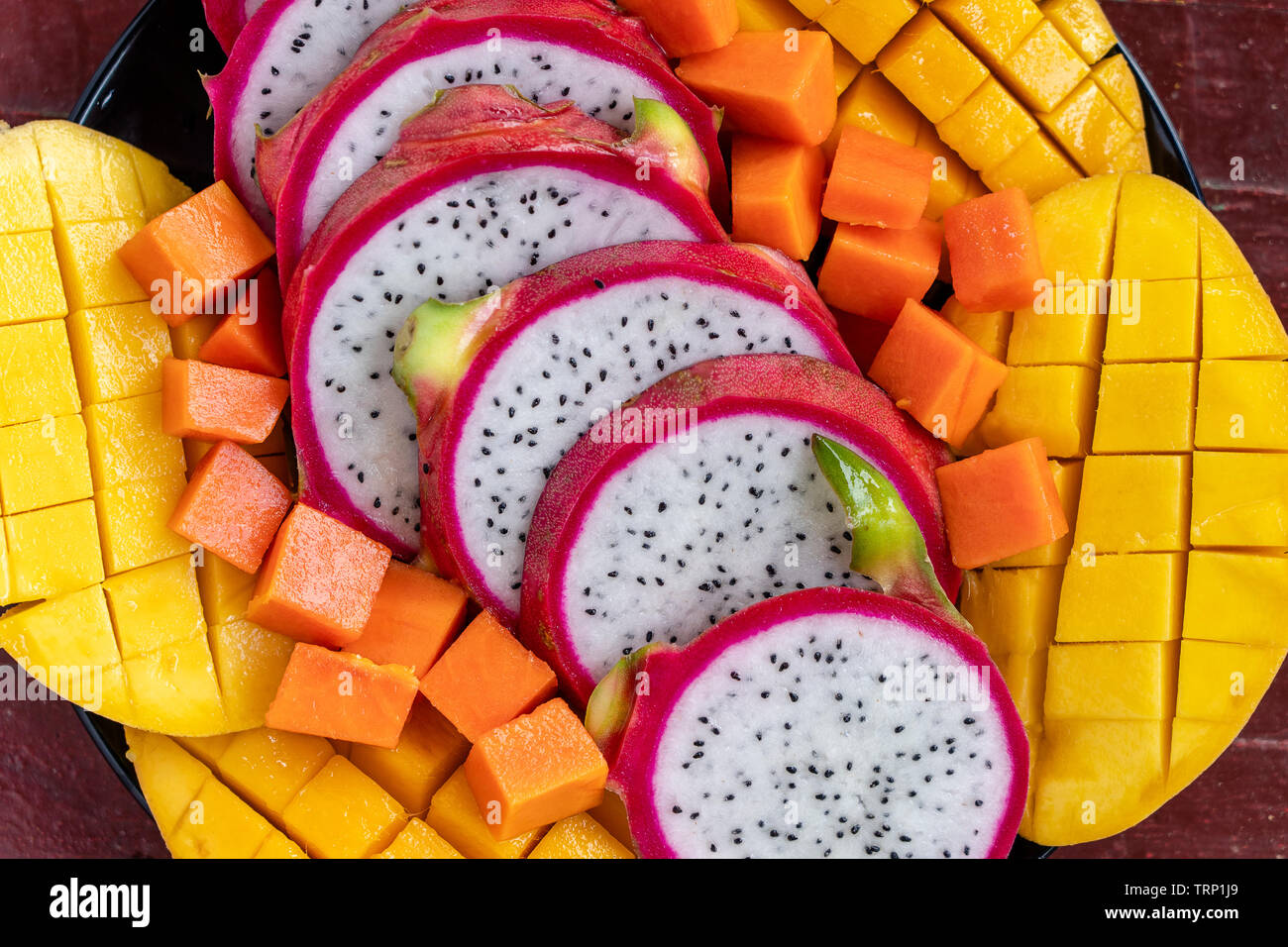 Tropical fruits assortment on a plate, close up. Many colorful ripe ...