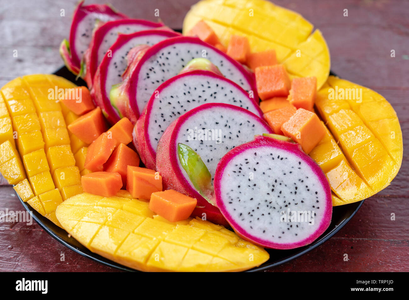 Tropical fruits assortment on a plate, close up. Many colorful ripe ...