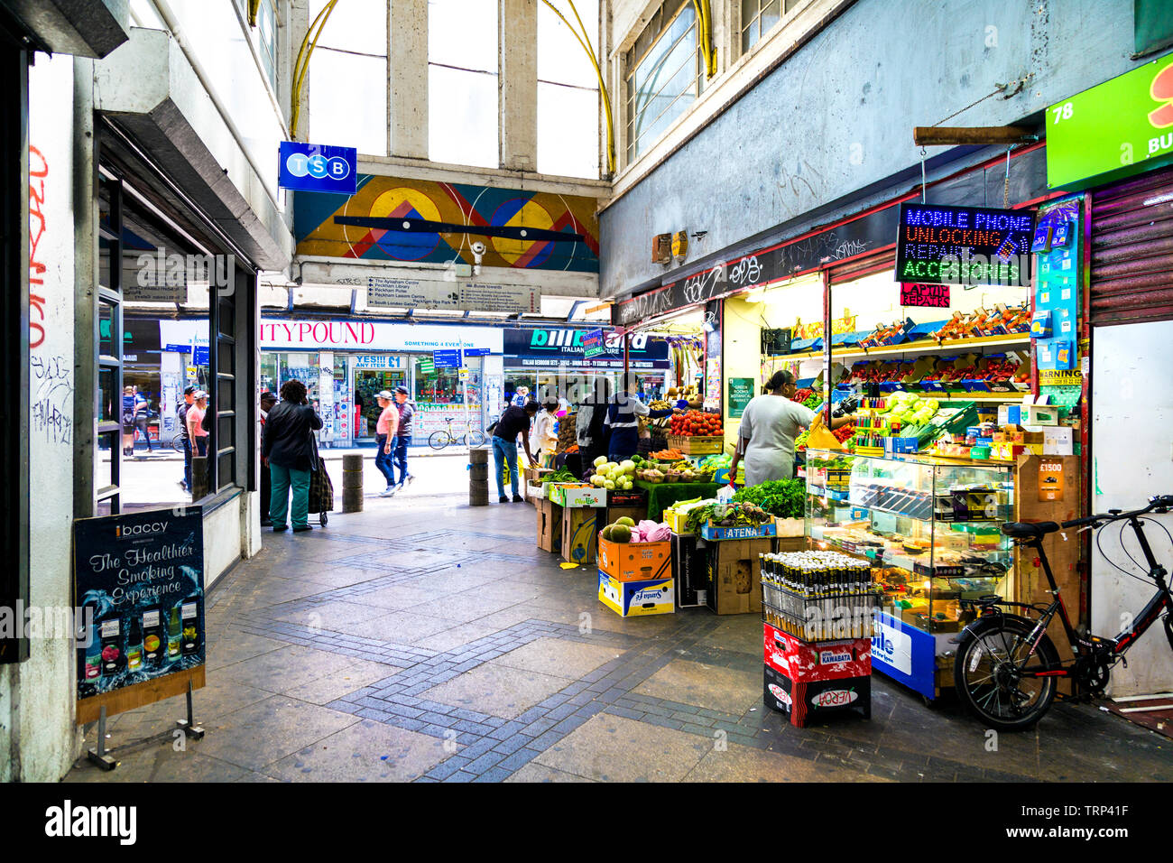 Fruit and veg stall in a run-down 1950s shopping arcade passage in ...