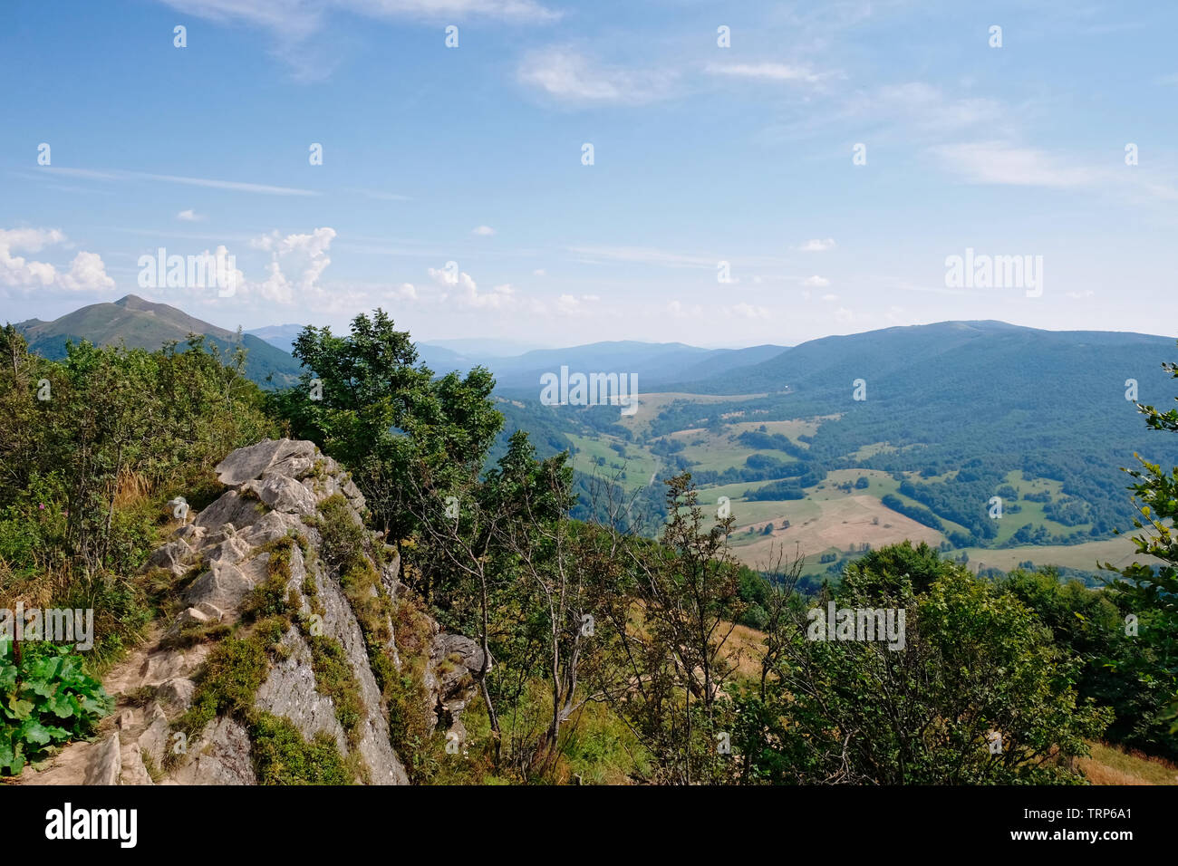 Mountain view landscape from hill over blue sky background Stock Photo ...