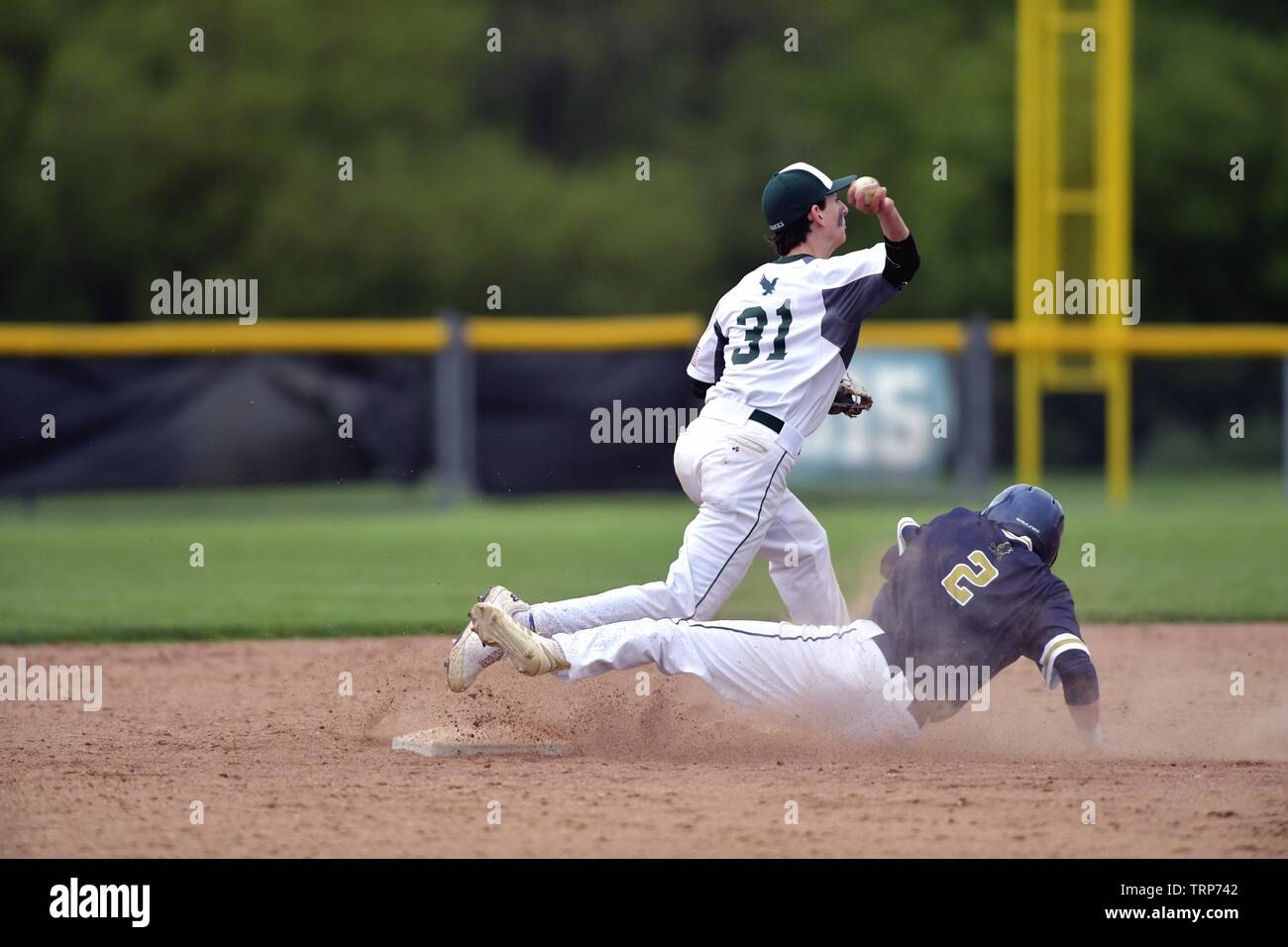 After retiring a sliding runner at second, a second baseman relays to ...