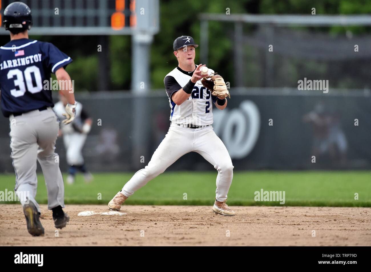 Shortstop catching the ball in his bare hand at second base to force an ...