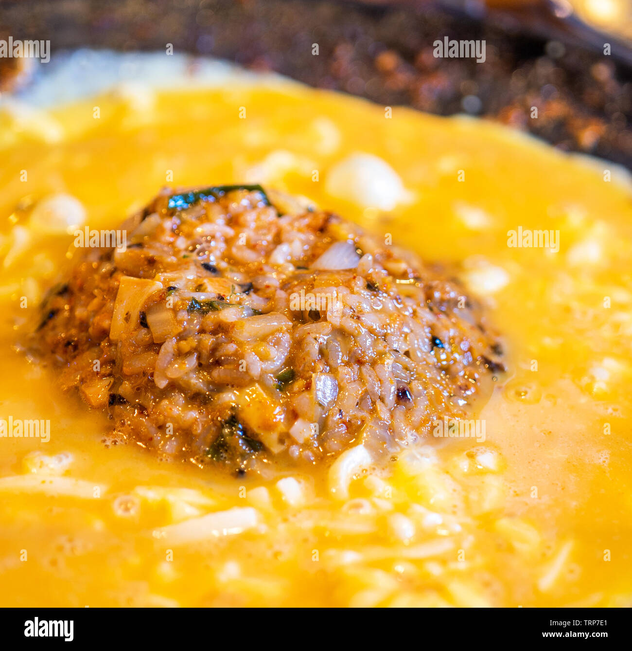 Delicious volcanic shaped fried rice with egg and spicy sauce, pork and ...