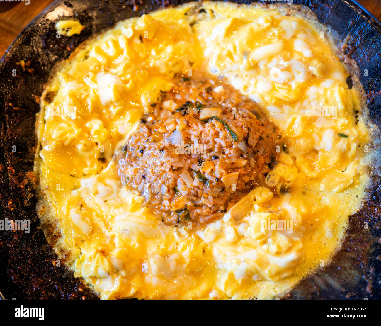 Delicious volcanic shaped fried rice with egg and spicy sauce, pork and ...